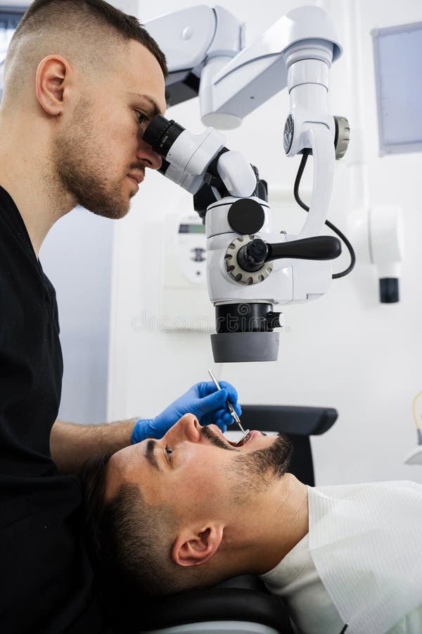 Surgical Microscope Examination Procedure. Dentist is Looking on Teeth ...
