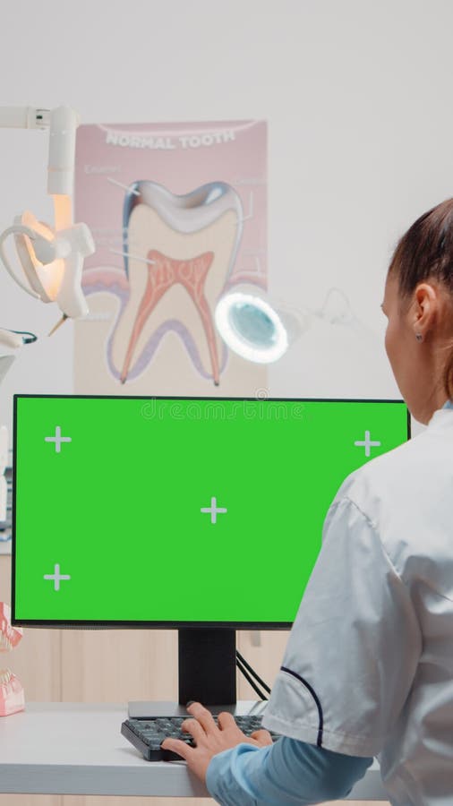 Dentist Using Computer with Horizontal Green Screen on Display Stock ...