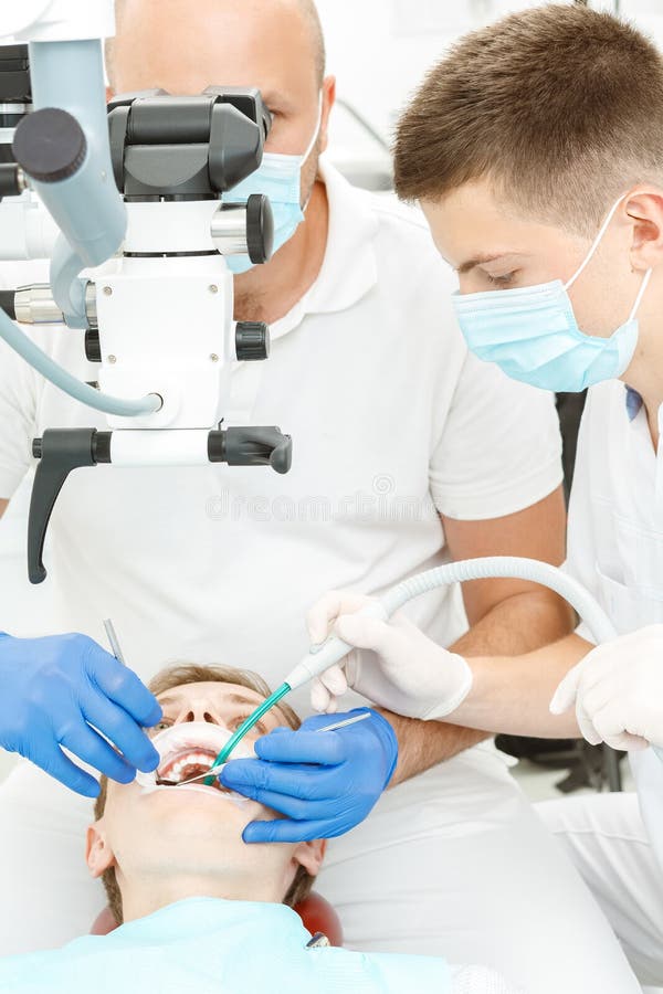 Dentist Using Dental Microscope during Inspection Stock Photo - Image ...
