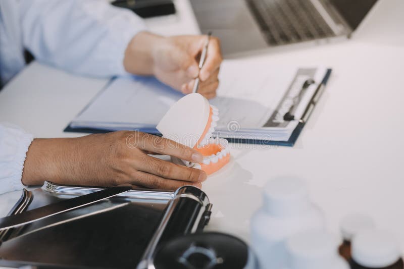 A Dentist is Using Specialized Dental Equipment To Inspect Dentures To ...