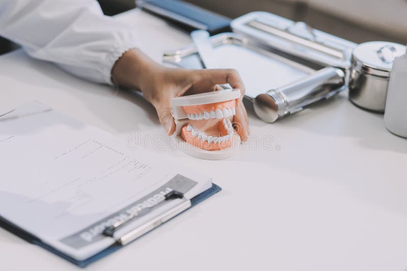 A Dentist is Using Specialized Dental Equipment To Inspect Dentures To ...