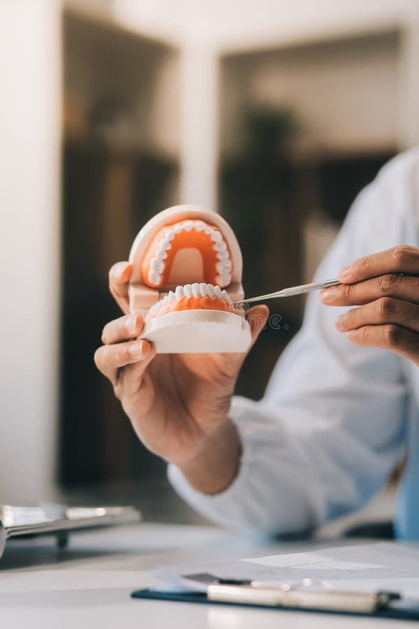 A Dentist is Using Specialized Dental Equipment To Inspect Dentures To ...