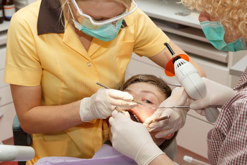 Dentist at work stock image. Image of teeth, person, mask - 27358245