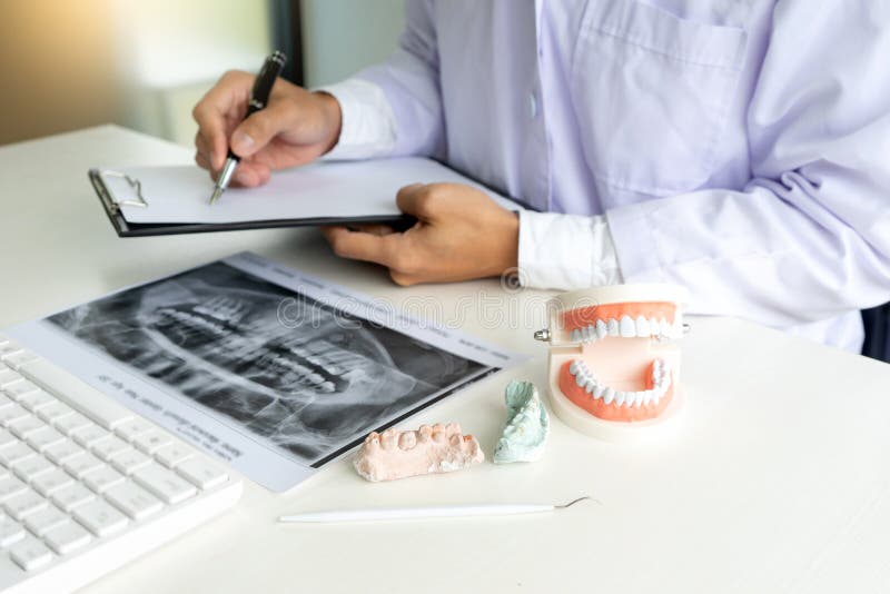 Dentist Work on the Table with Denture and Teeth X-ray Stock Photo ...
