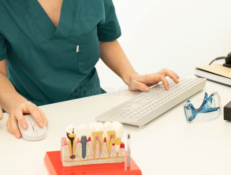 Dentists Implantologists Look at the Computer. on the Table There is a ...