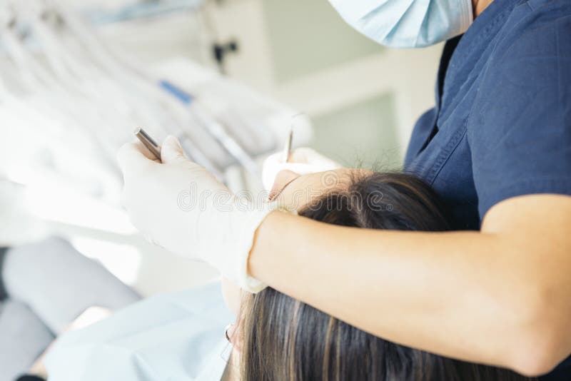 Dentists with a Patient during a Dental Intervention. Stock Photo ...