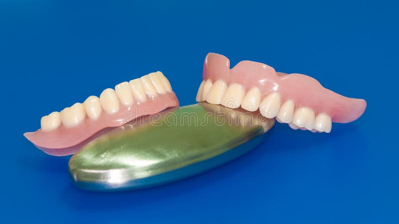 Denture on a Blue Background Stock Photo - Image of equipment ...