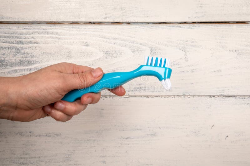Denture Toothbrush in Hand. Effective Cleaning of Teeth and Gums Stock ...