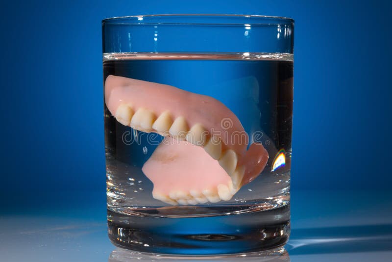 Denture in water glass stock image. Image of caries, dentistry - 35522409
