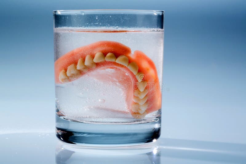 Dentures in water glass stock image. Image of health - 52672747