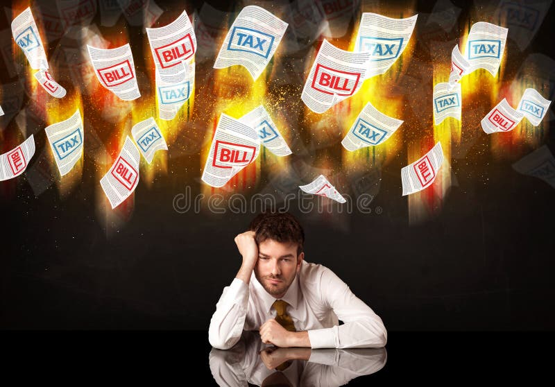 Depressed Businessman Sitting Under Burning Tax and Bill Papers Stock ...