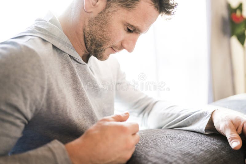 Depressed Man at Home on Couch Look Sad Stock Image - Image of crisis ...