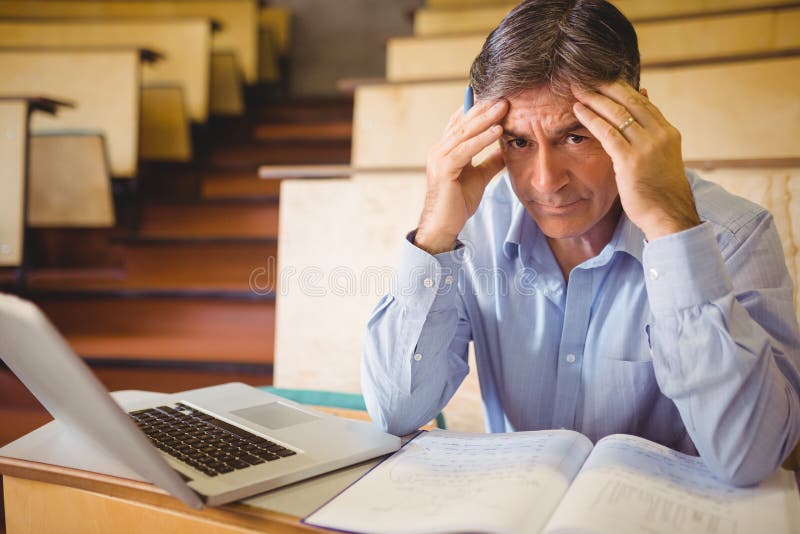 Depressed Professor Sitting with Notes and Laptop Stock Photo - Image ...
