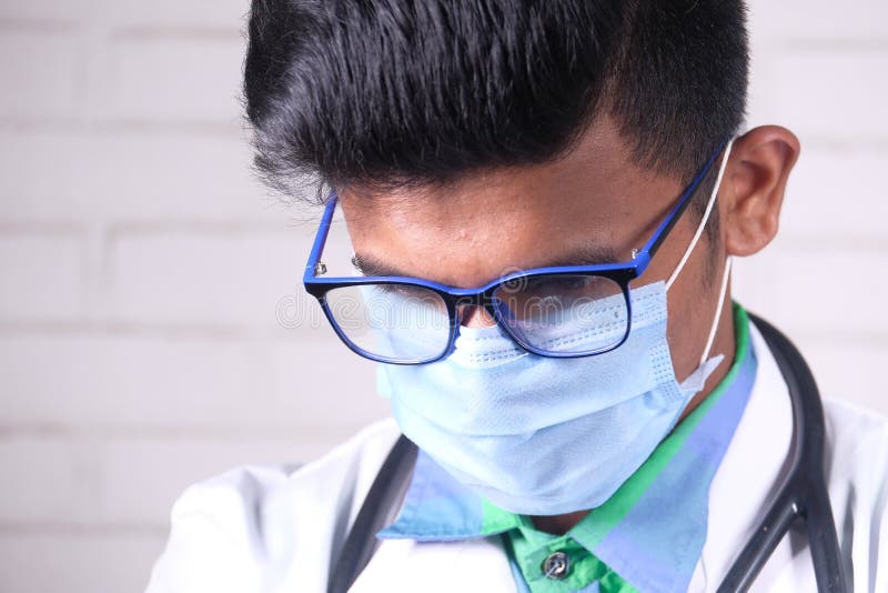 Depressed Sad Doctor in Face Mask Looking Down Stock Photo - Image of ...