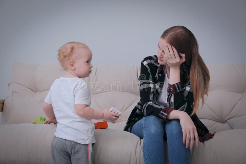 Depressed Single Mother with Child in Living Room Stock Image - Image ...