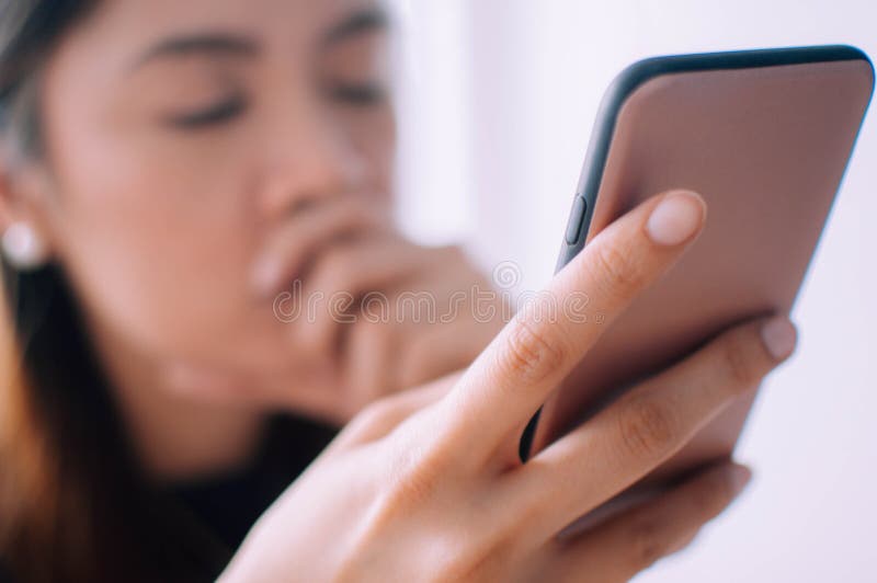 A Depressed Young Woman is Using a Mobile Phone Stock Photo - Image of ...