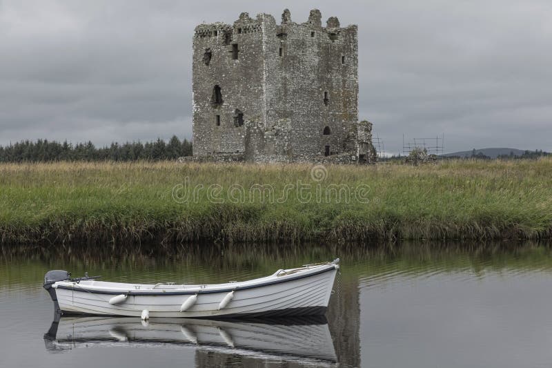 Derelict Castle with White Boat in Water with a Reflection Stock Image ...
