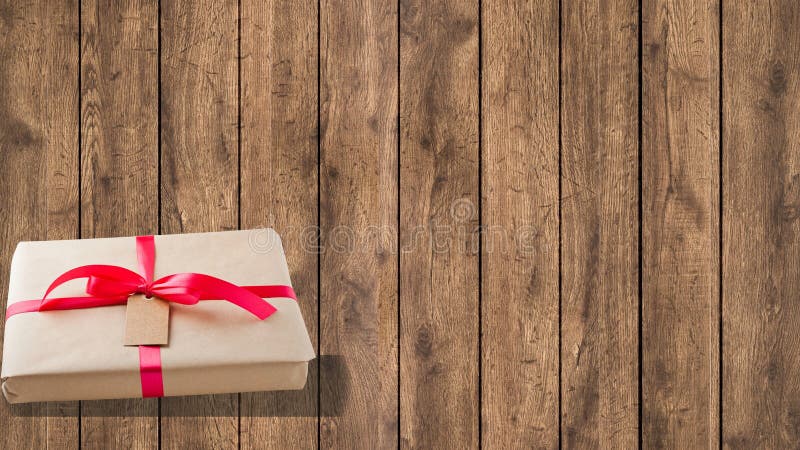 Gift Wrapped in Brown Paper with a Bright Red Ribbon and Bow on a ...