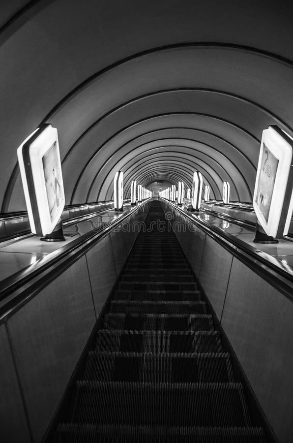 Descent on the Escalator in the Metro. Light Boxes Along the Tunnel ...