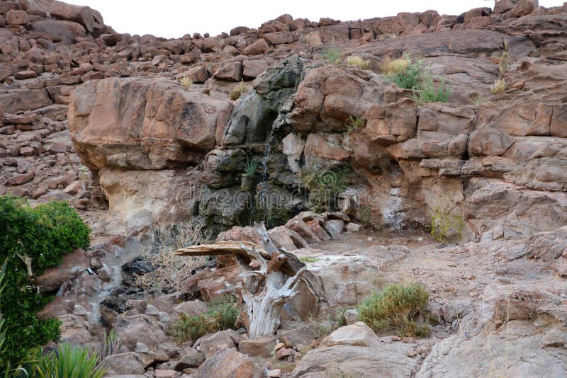 In a Desert Arid Area, a Small Waterfall Flows Over the Stones Stock ...