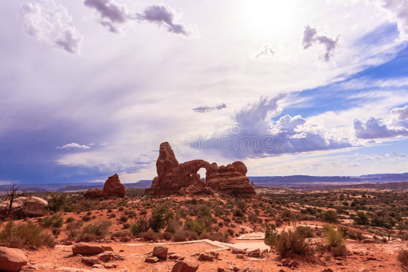 A Desert Landscape with a Large Rock Formation and a Cloudless Sky ...