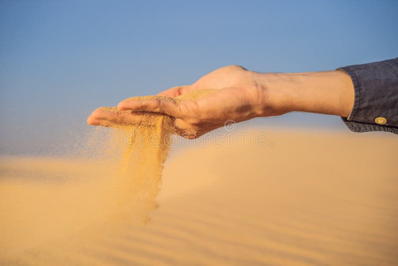 Desert, Sand Puffs through the Fingers of a Mans Hand Stock Photo ...
