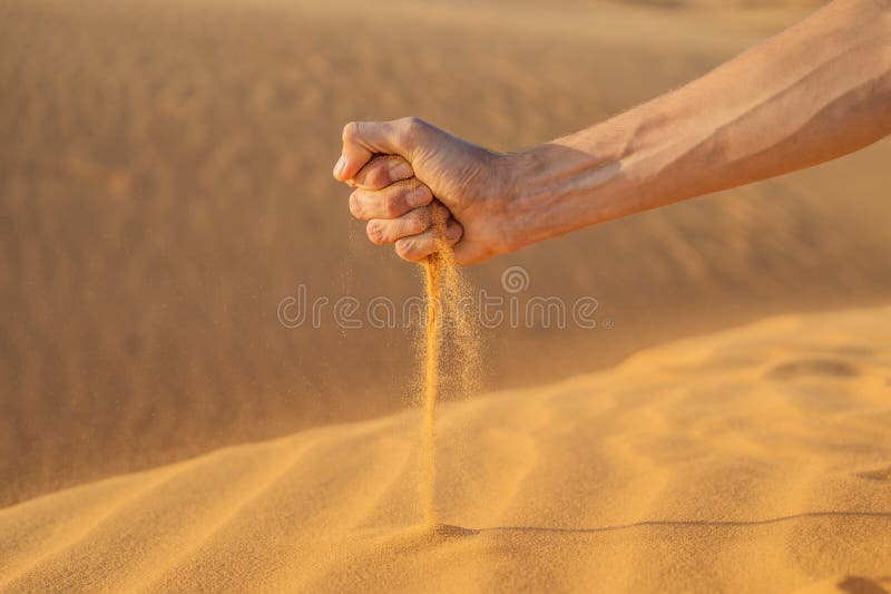Desert, Sand Puffs through the Fingers of a Mans Hand Stock Photo ...