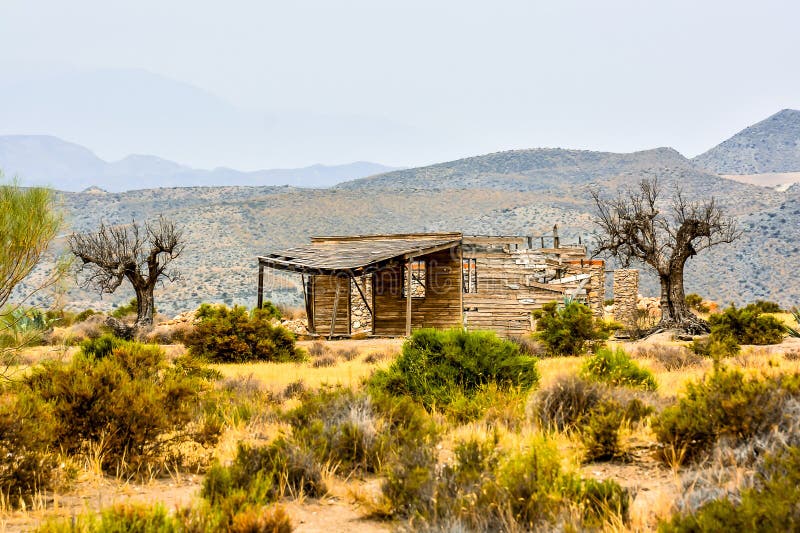 A Deserted Landscape with a Small House and Two Trees Stock Image ...