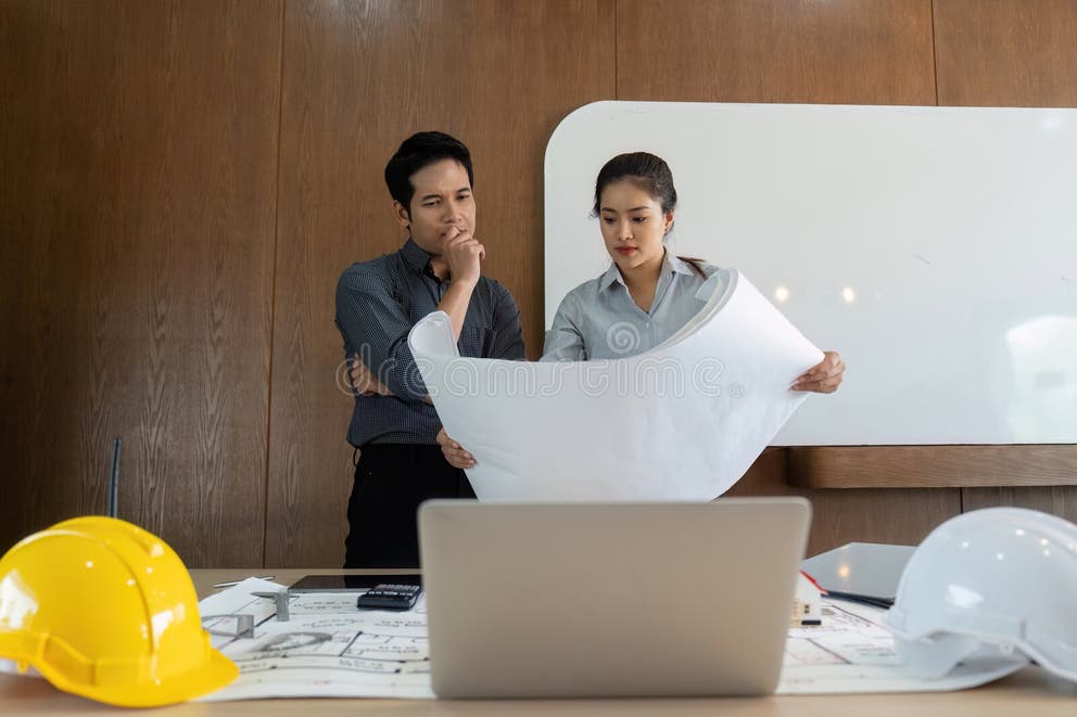 Design and Analysis. Engineers Analyzing Blueprints Together for a Construction Project. Stock ...