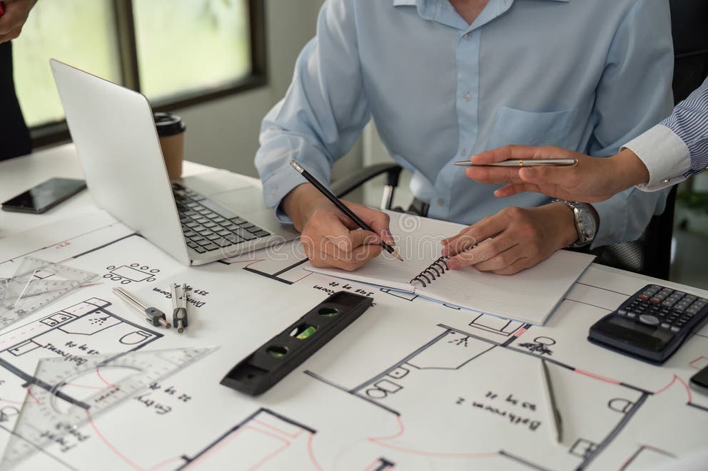 Design and Drafting. an Architect Taking Notes while Collaborating on ...