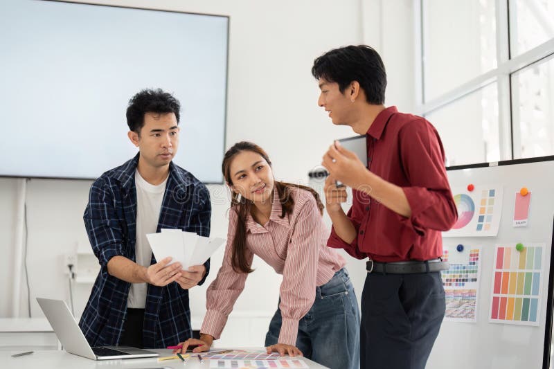 Design and Engagement. a Creative Team in a Modern Workspace Reviewing ...