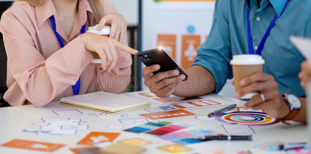 Design Team Engaging in Creative Process. Professionals Analyzing Designs and Discussing Ideas ...