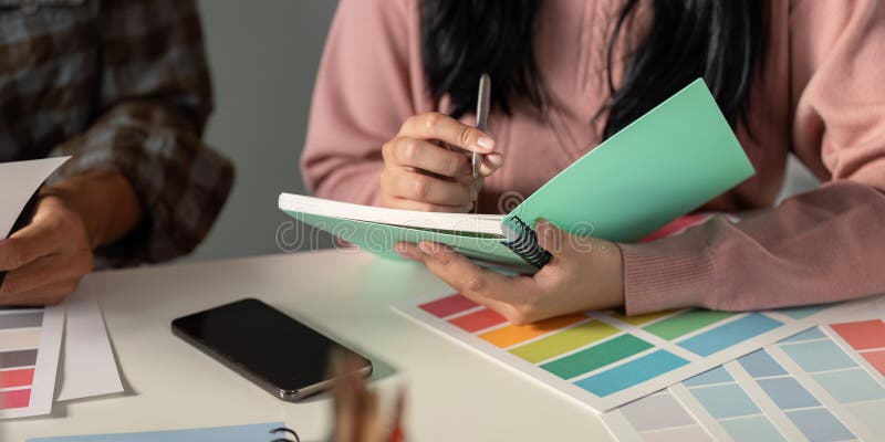 Creative Design Team Collaborating on Graphics in a Modern Workspace ...