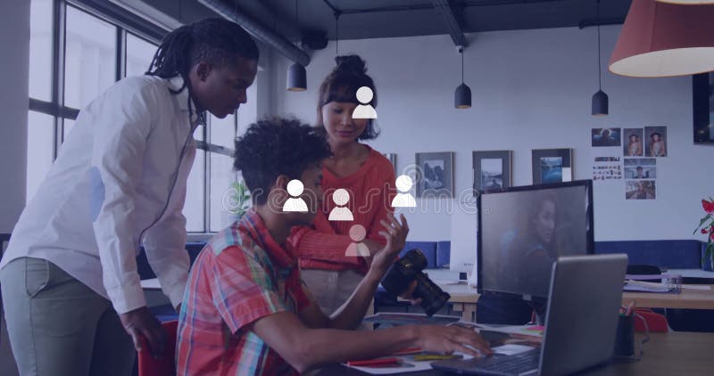 Design Team Collaborating Around Desk in Tech Office, with Floating ...