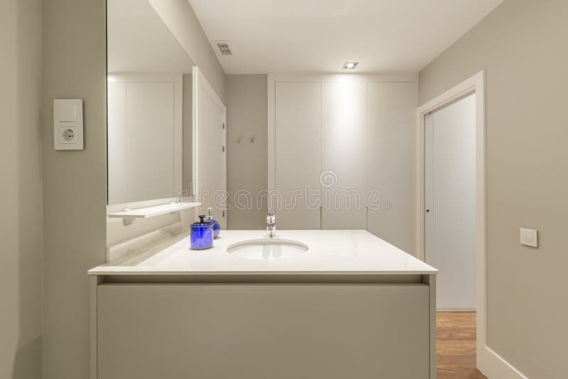Designer Bathroom with Central Marble Sink and Built-in Cabinets with ...