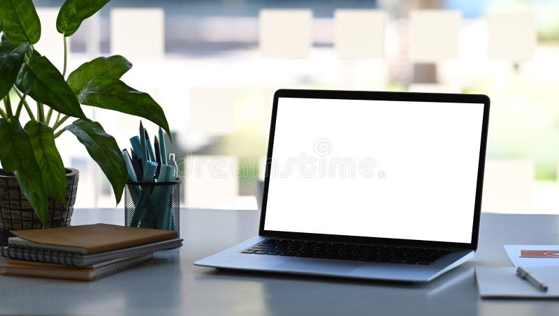 Designer Comfortable Workspace with Empty Screen Laptop Near the Window ...