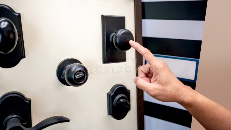 Designer Hand Pointing at Vintage Solid Door Knob on Sample Collection ...