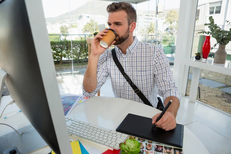 Designer Having Drink Writing On Graphics Tablet Stock Image - Image of ...