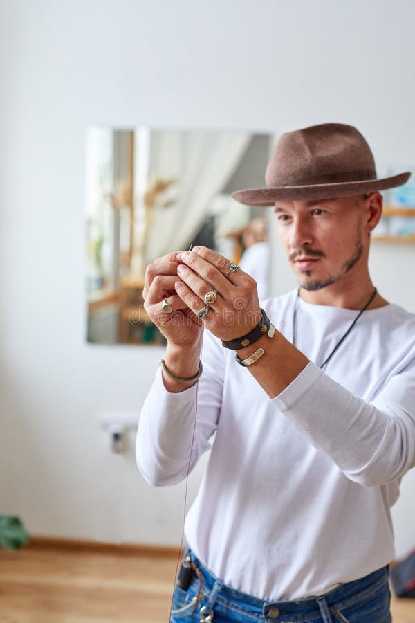 Designer Male Puts Thread in a Needle for Sewing a Hat Stock Image ...