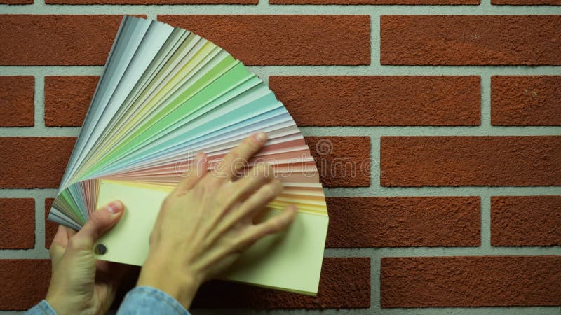 The Designer Opens a Paper Catalog of Color Samples on the Background ...