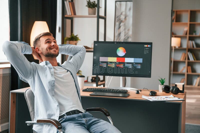 Designer is Sitting by the Computer and Using Graphics Tablet with ...