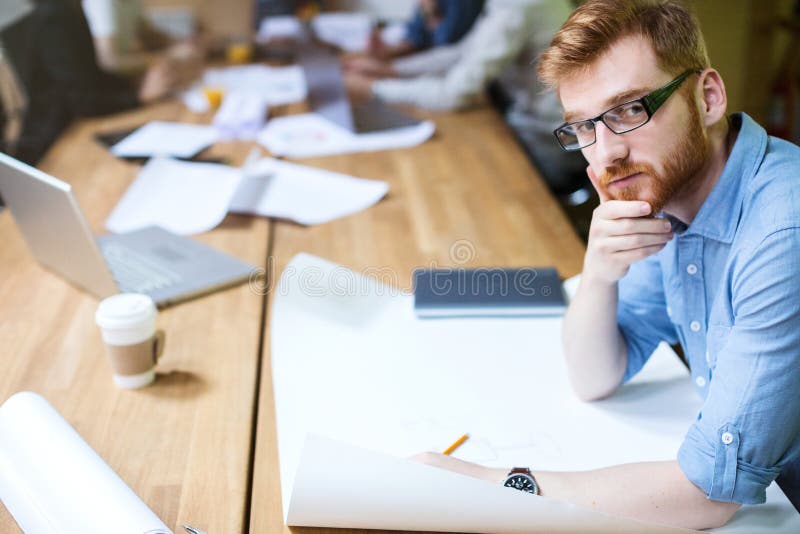Designer Sitting beside Desk in Modern Studio. Stock Photo - Image of ...