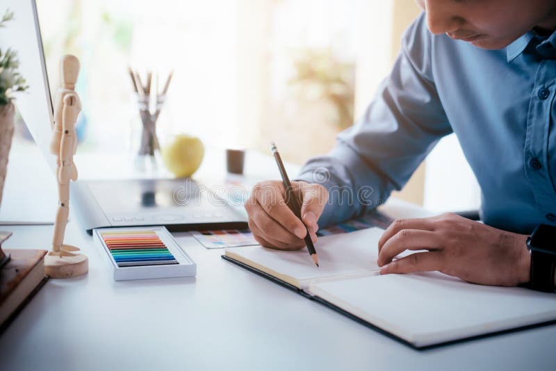 Designer sketch something. stock image. Image of table - 124745519