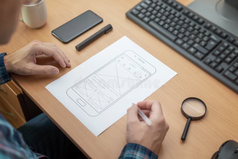 The Designer Sketches, Draws the Layout of a Mobile Phone App on a ...
