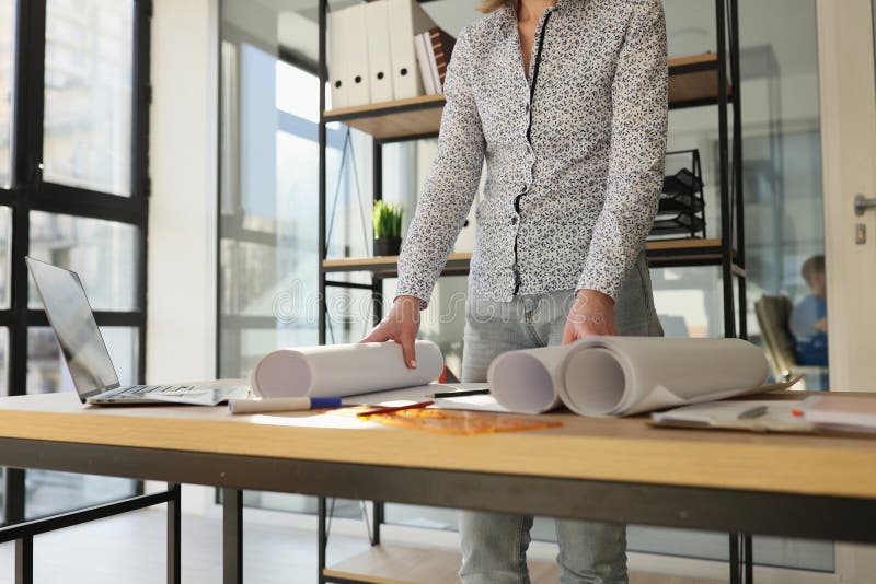 Designer Standing Near Work Desk with Rolls of Paper Stock Image ...