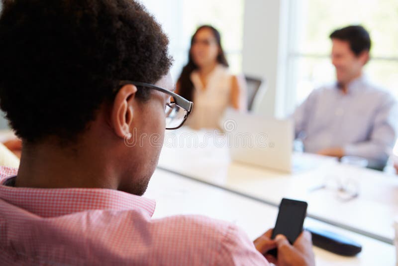 Designer Using Mobile Phone during Meeting Stock Image - Image of ...