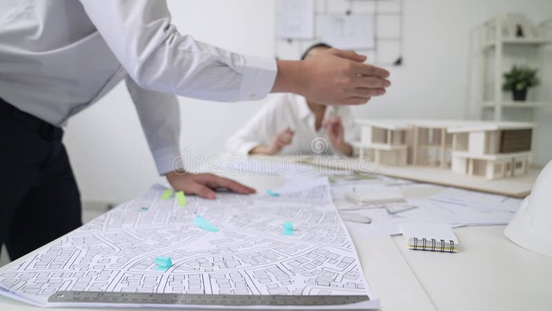 Designer Working while Discussing with Engineer about House Plan ...