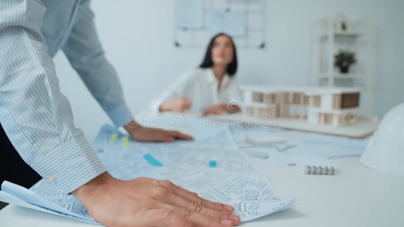 Designer Working while Discussing with Engineer about House Plan ...