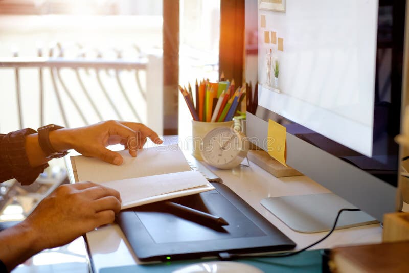 Designer Working and Writing with Notebook, Desktop Computer at Desk ...