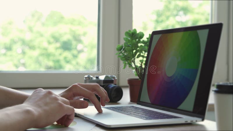 Designer Works on a Laptop with a Color Palette. . Stock Video - Video ...
